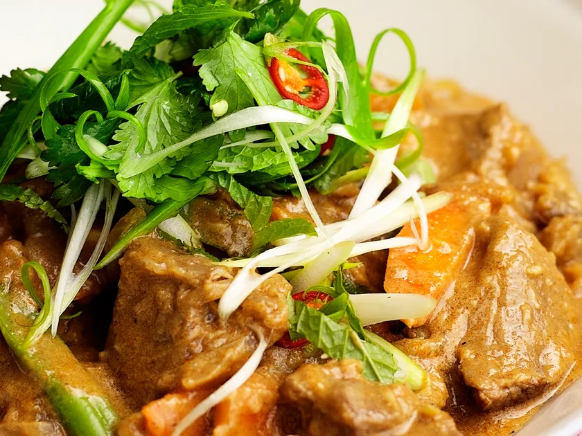 Beef rendang topped with a fresh salad recipe