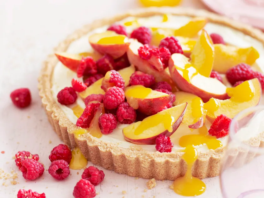 Peach and raspberry tart with mango coulis