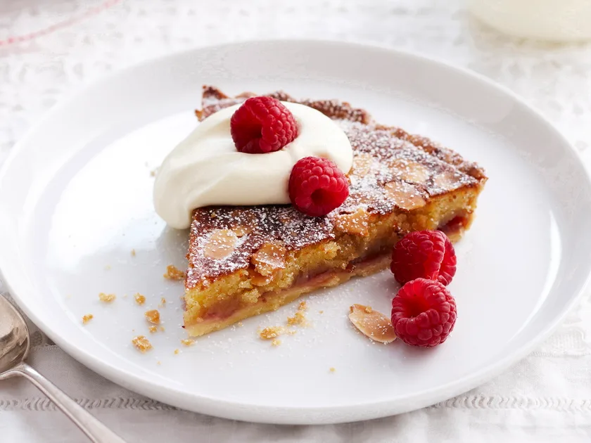 Bakewell tart with whipped cream and berries