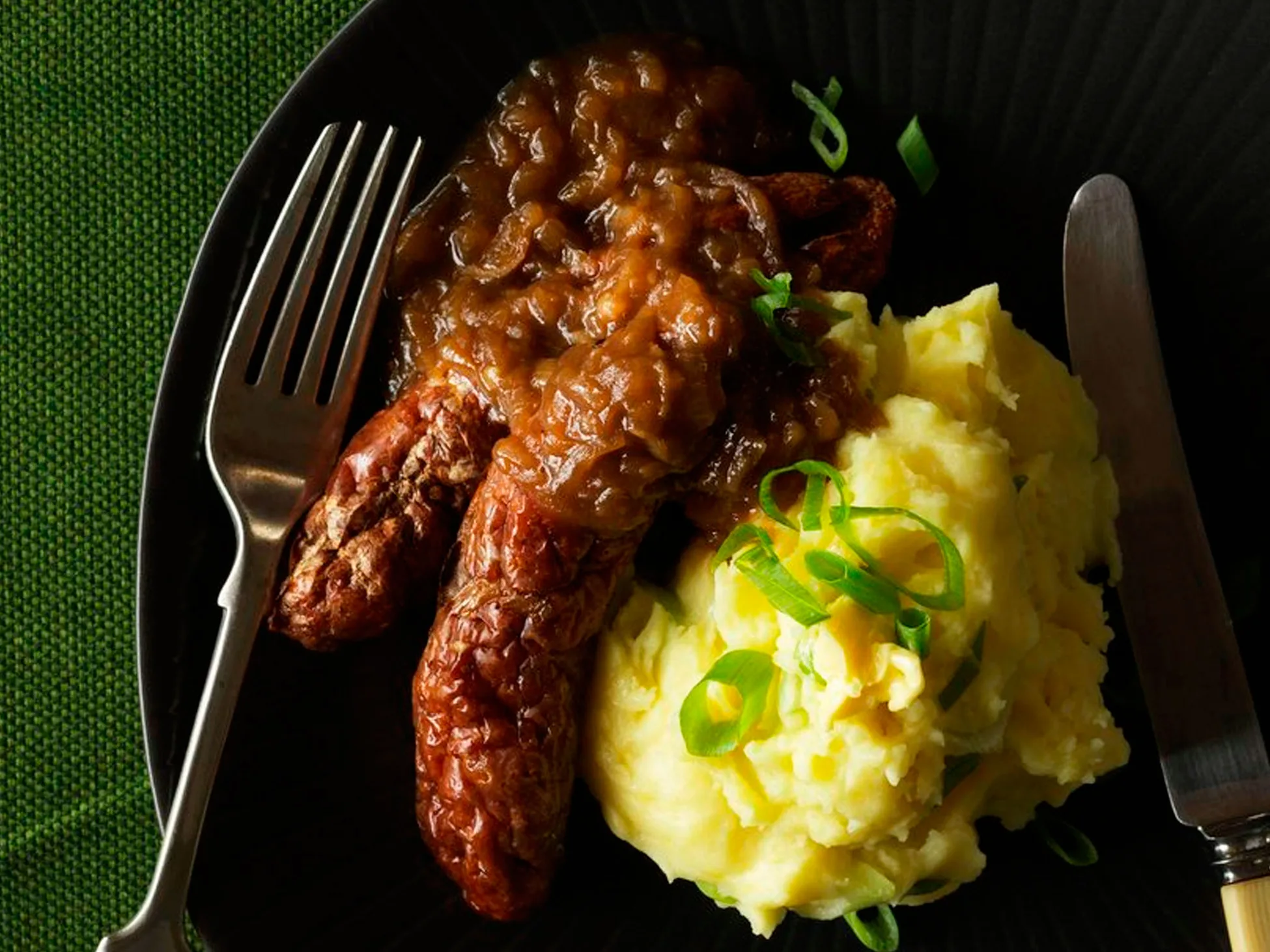 Champ with sausages and brown onion gravy