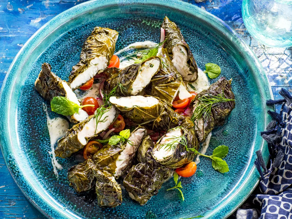 Fish fillets baked in vine leaves with yoghurt sauce