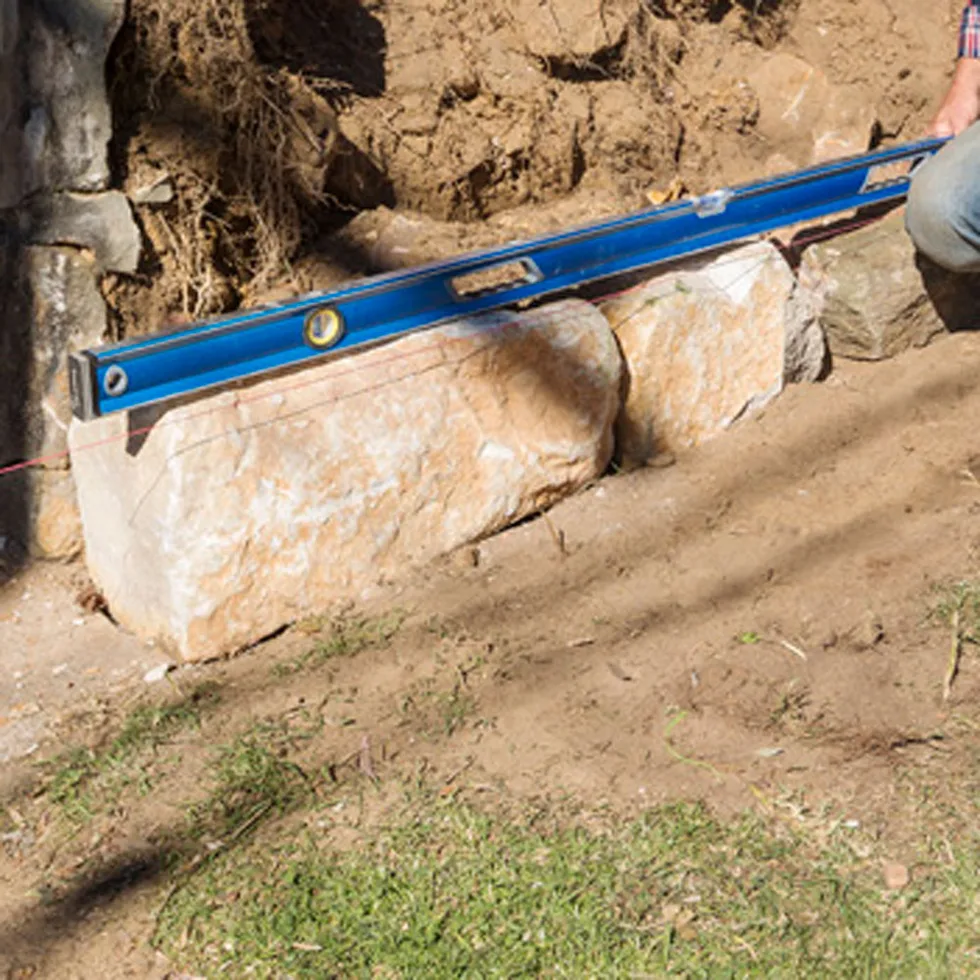 How to build a stacked sandstone wall | Better Homes & Gardens Australia