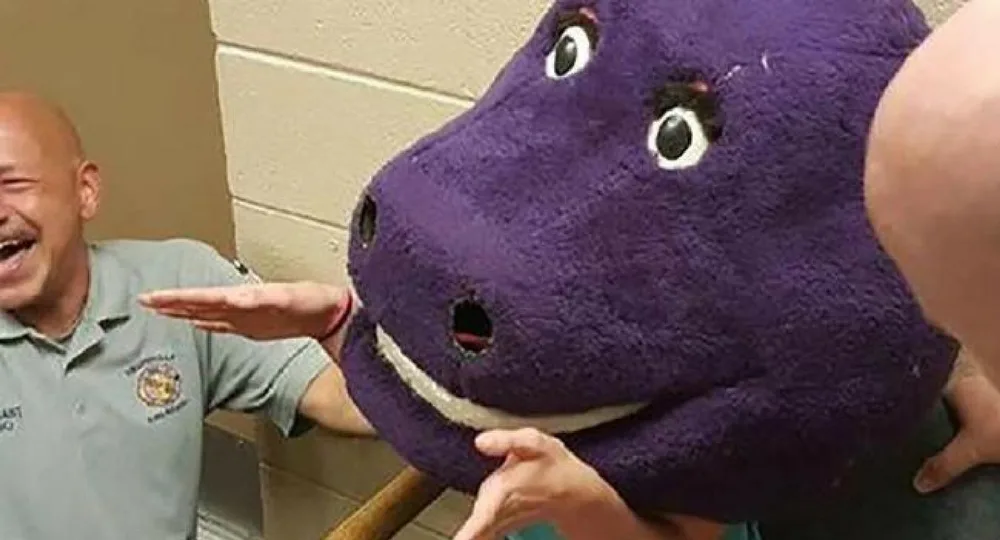 Teenager gets stuck inside giant Barney head for AN HOUR after trying ...