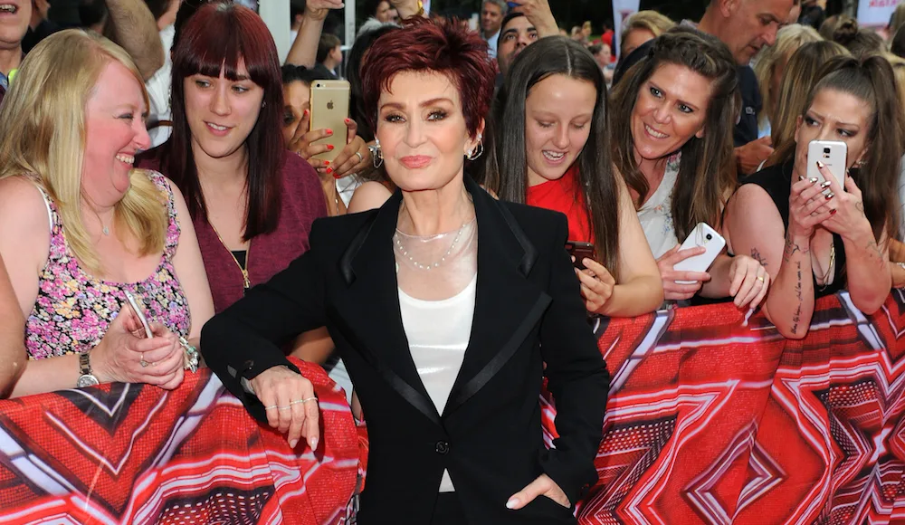 Sharon Osbourne pictured smiling with fans despite marriage troubles. | WHO