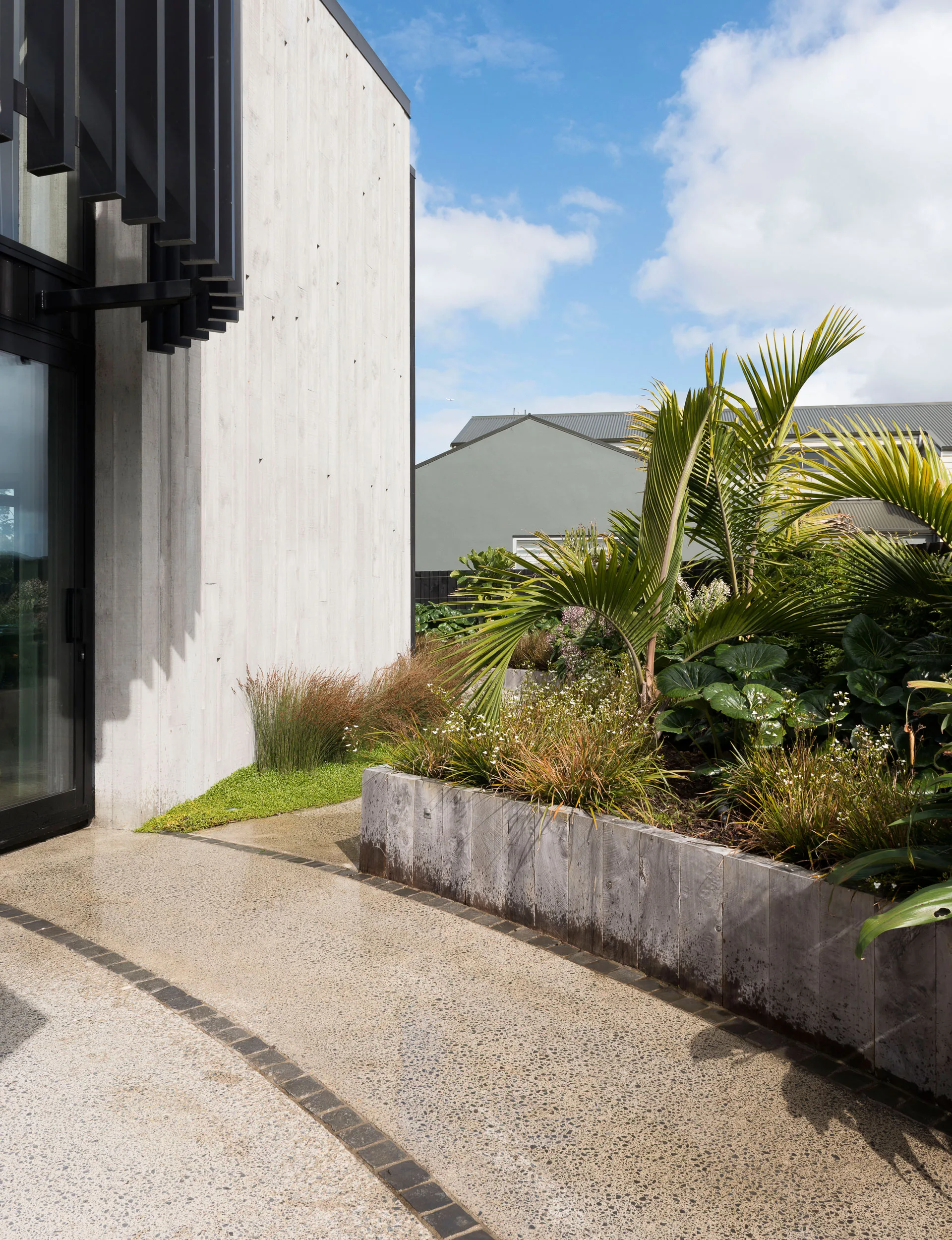 A new-build uses native planting to blend into its mangrove surroundings