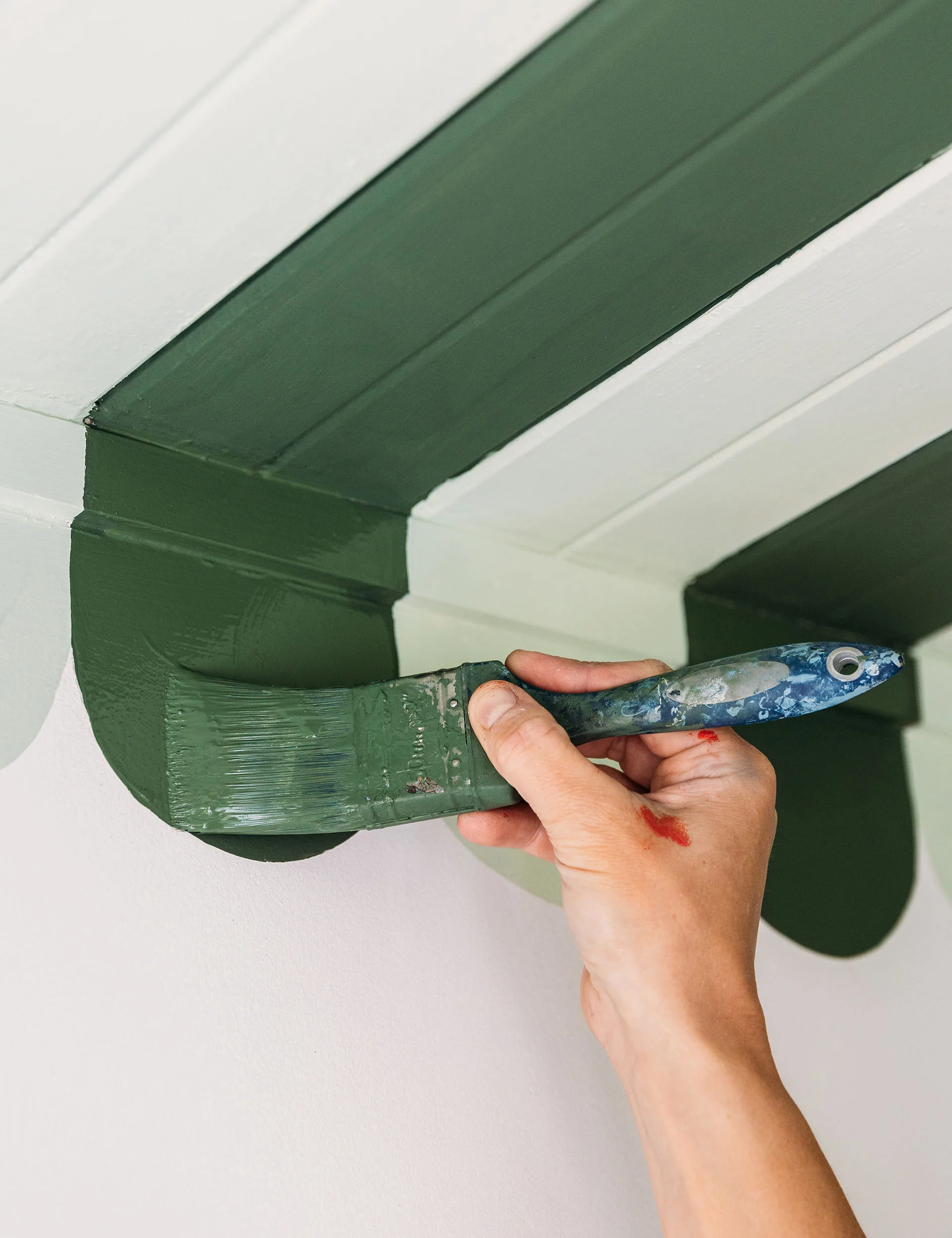 Paint your laundry room with a striped ceiling and stencilled writing