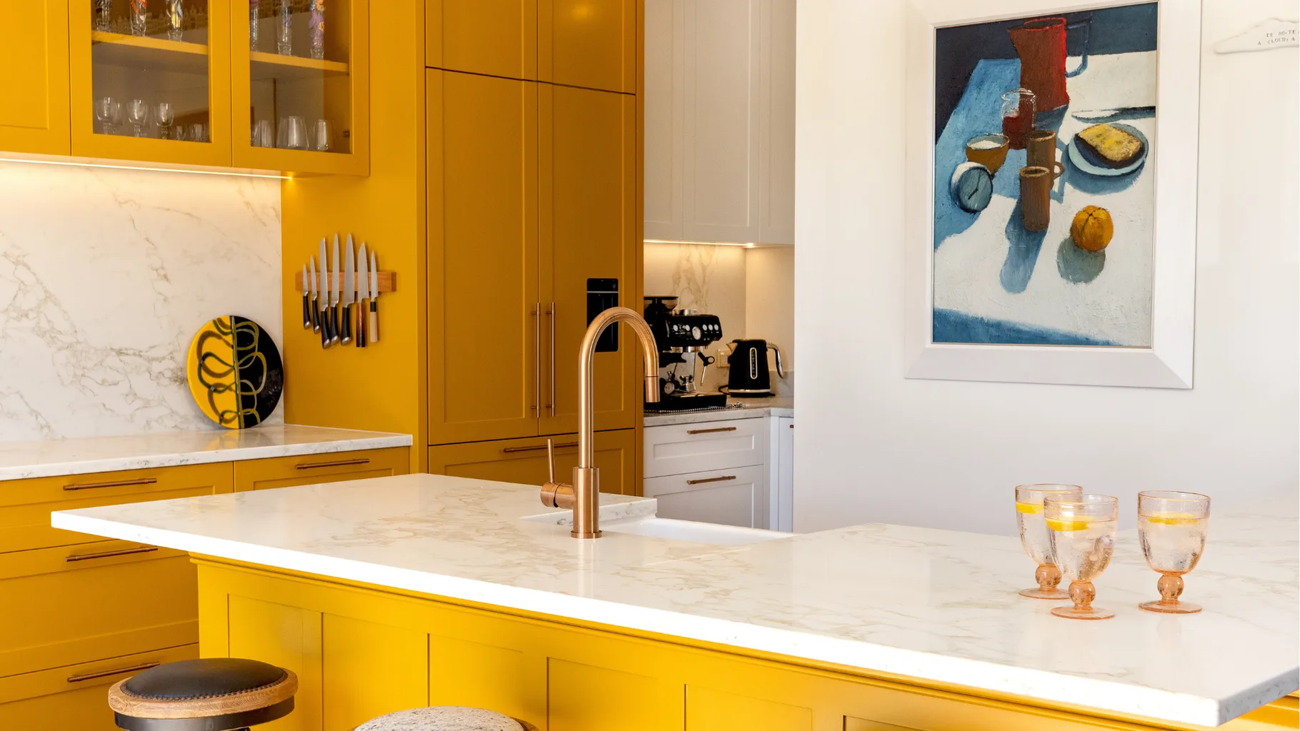 See inside this bright yellow kitchen and deep red wine cellar