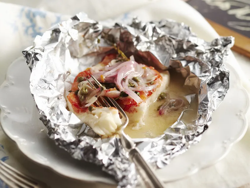 Foil-wrapped fish with tomato, onion, and capers