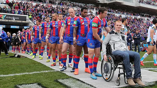 Newcastle Knights' player Alex McKinnon stands up alone