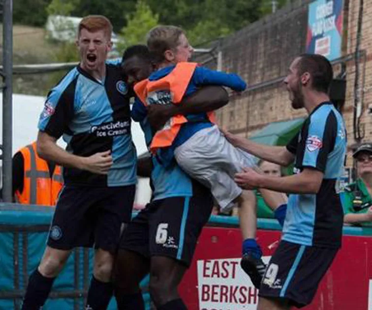 Ball boy, Taylor Hunt, celebrates goal with players
