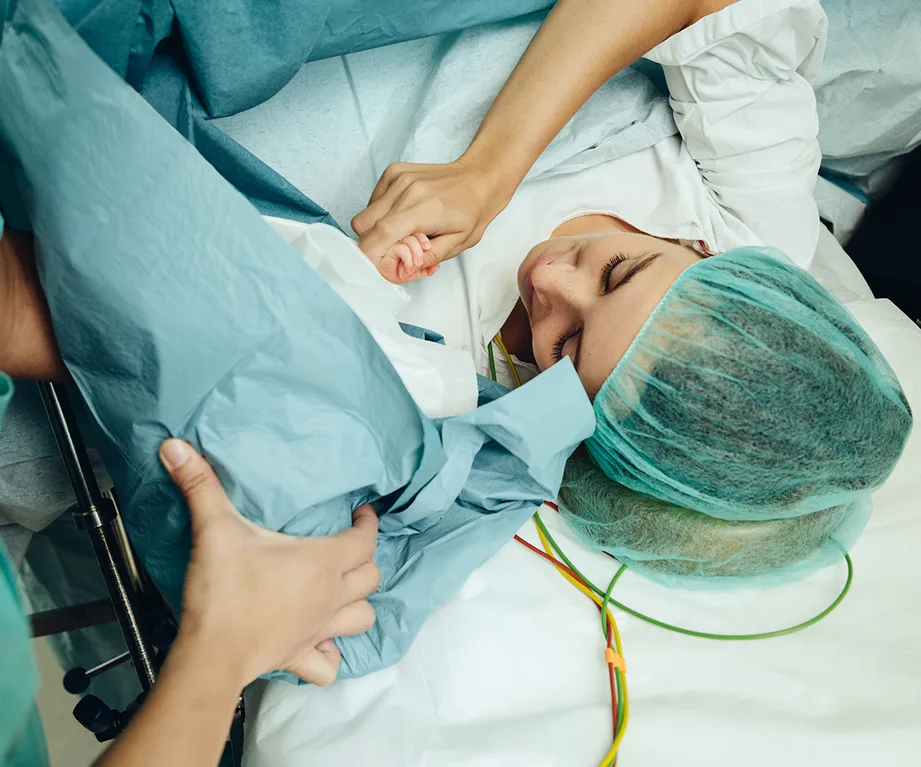 Mum delivers her son with her bare hands via C-section