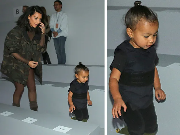 Kim Kardashian plays with North West at Kanye's show