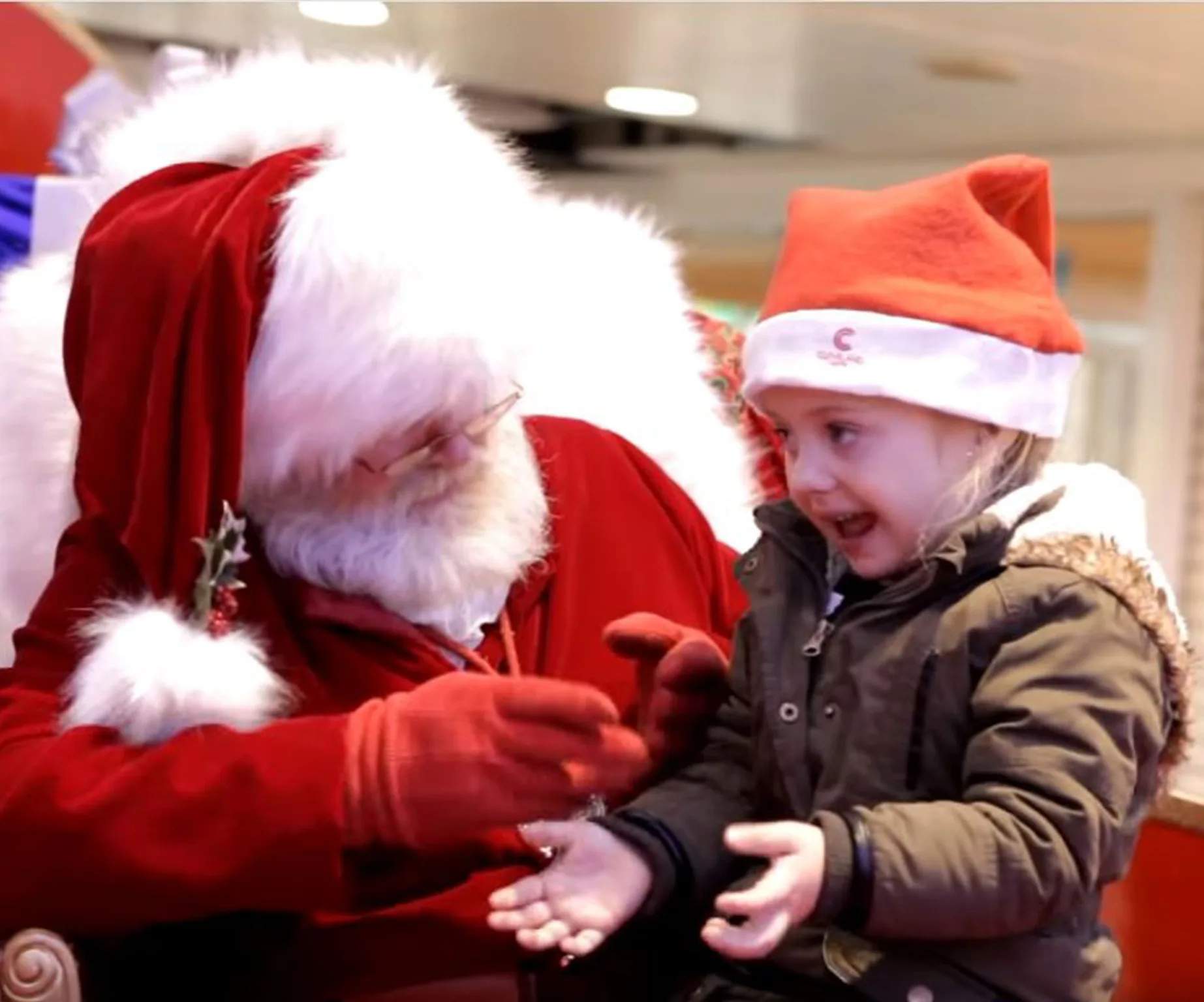 Santa Claus uses sign language for a little girl