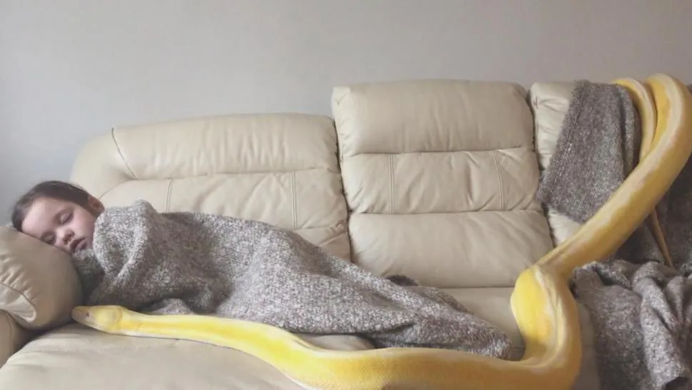 This little girl loves her pet python