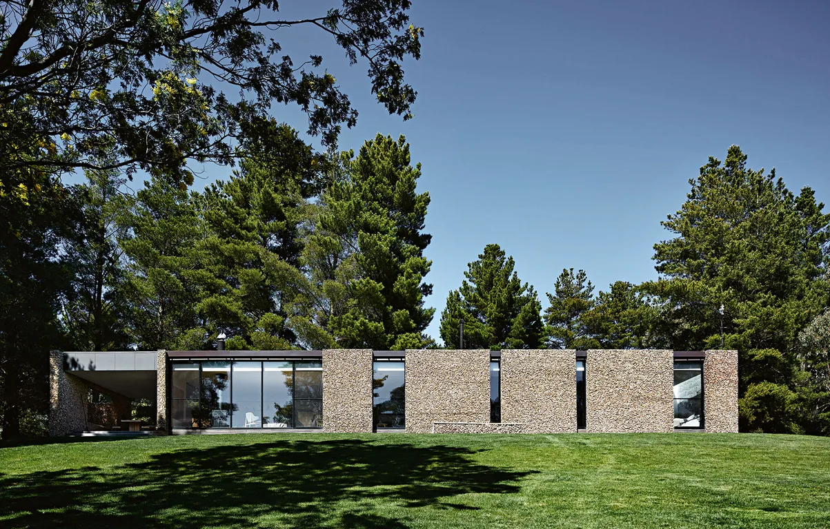A gabion wall forms this country home's stylish facade