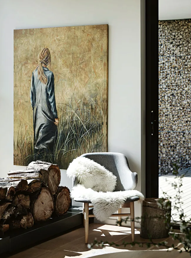 A gabion wall forms this country home's stylish facade