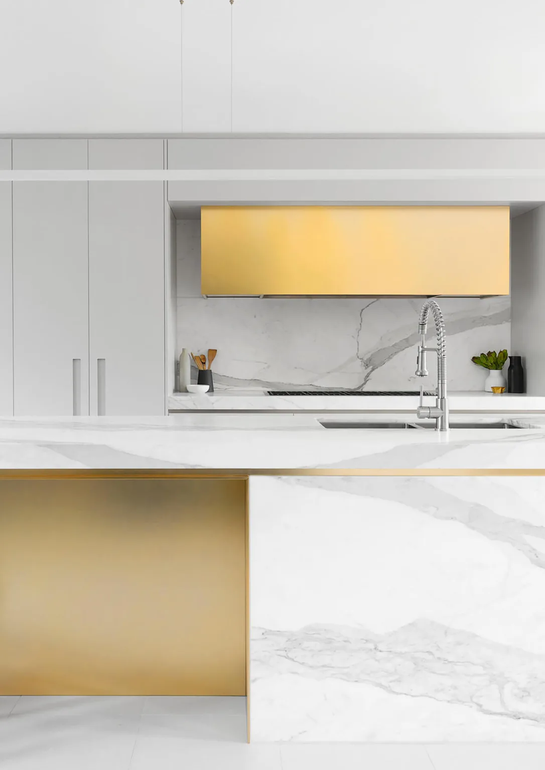 A modern kitchen with gold and grey accents