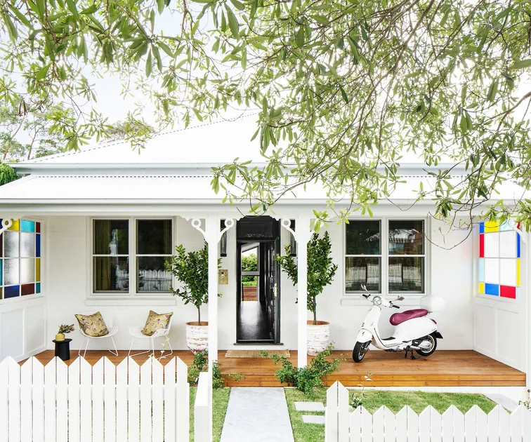 An all-white cottage with a glamorous interior