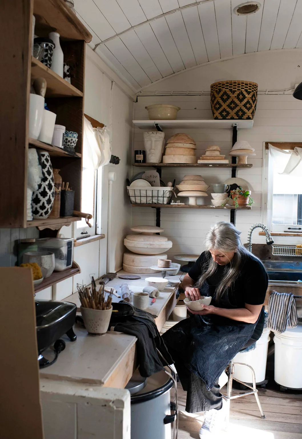 Inside a potter's converted train carriage studio