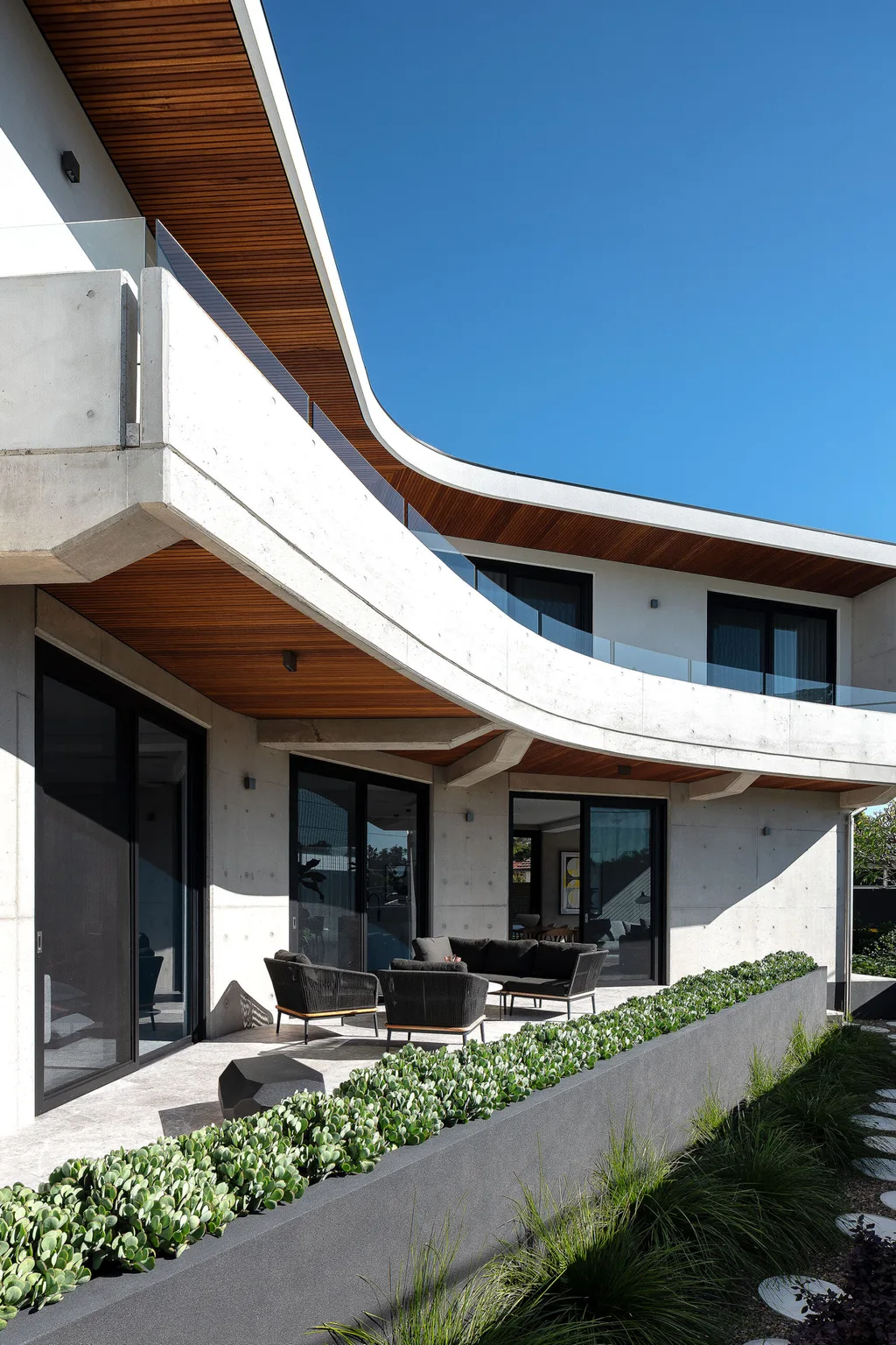 Tour a striking X-shaped home that functions around family