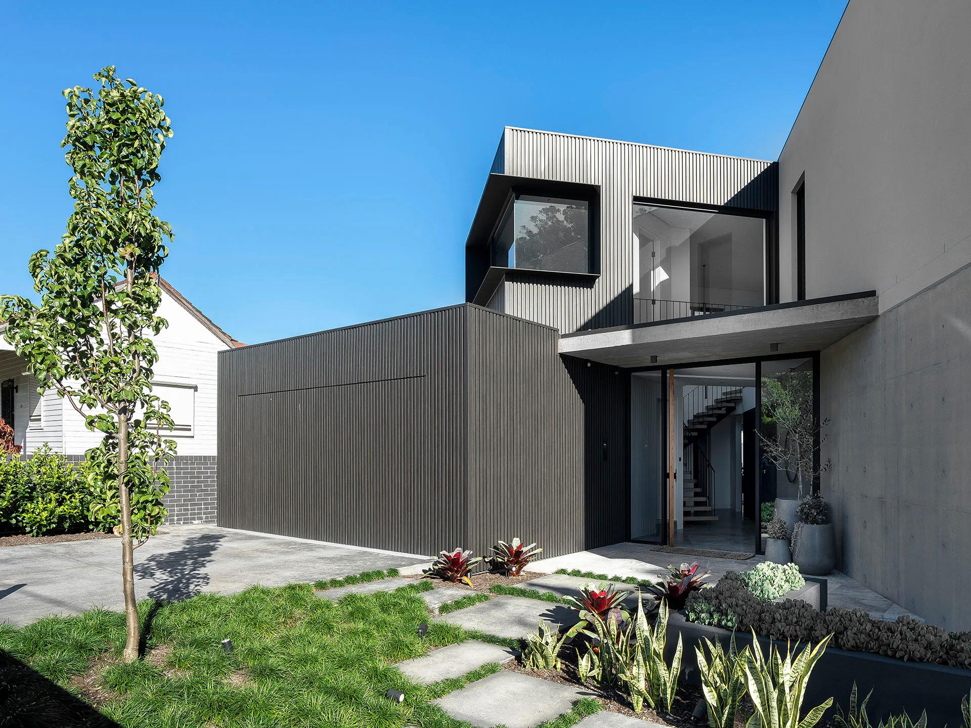 Tour a striking X-shaped home that functions around family